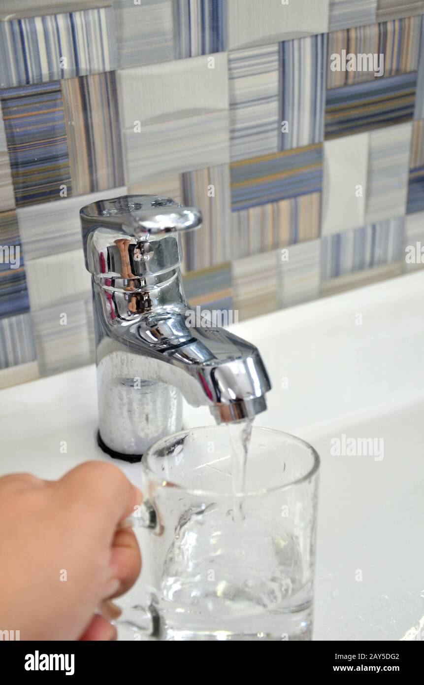 Hand pouring water from steel hi-res stock photography and images - Alamy