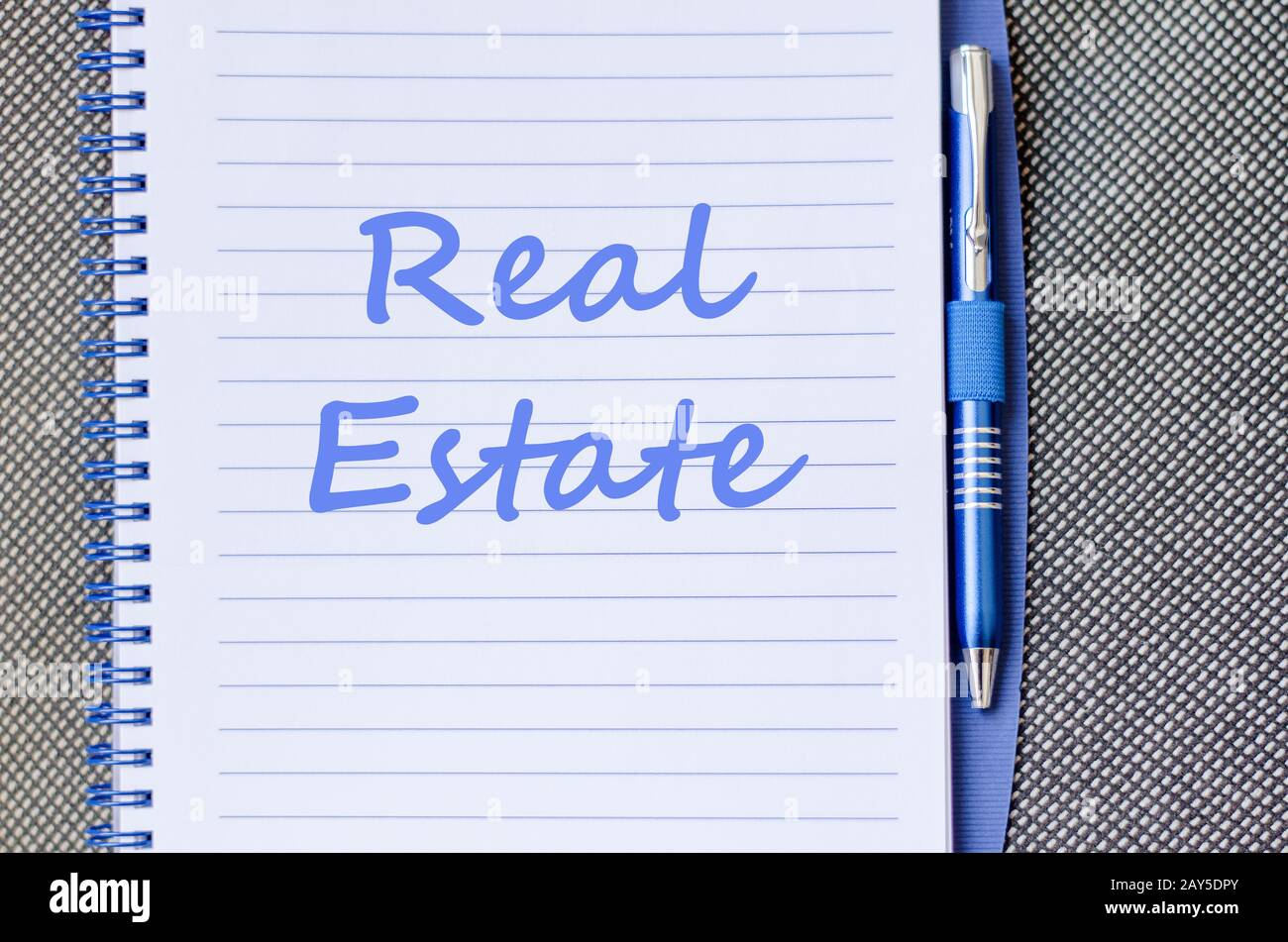 Real estate write on notebook Stock Photo - Alamy