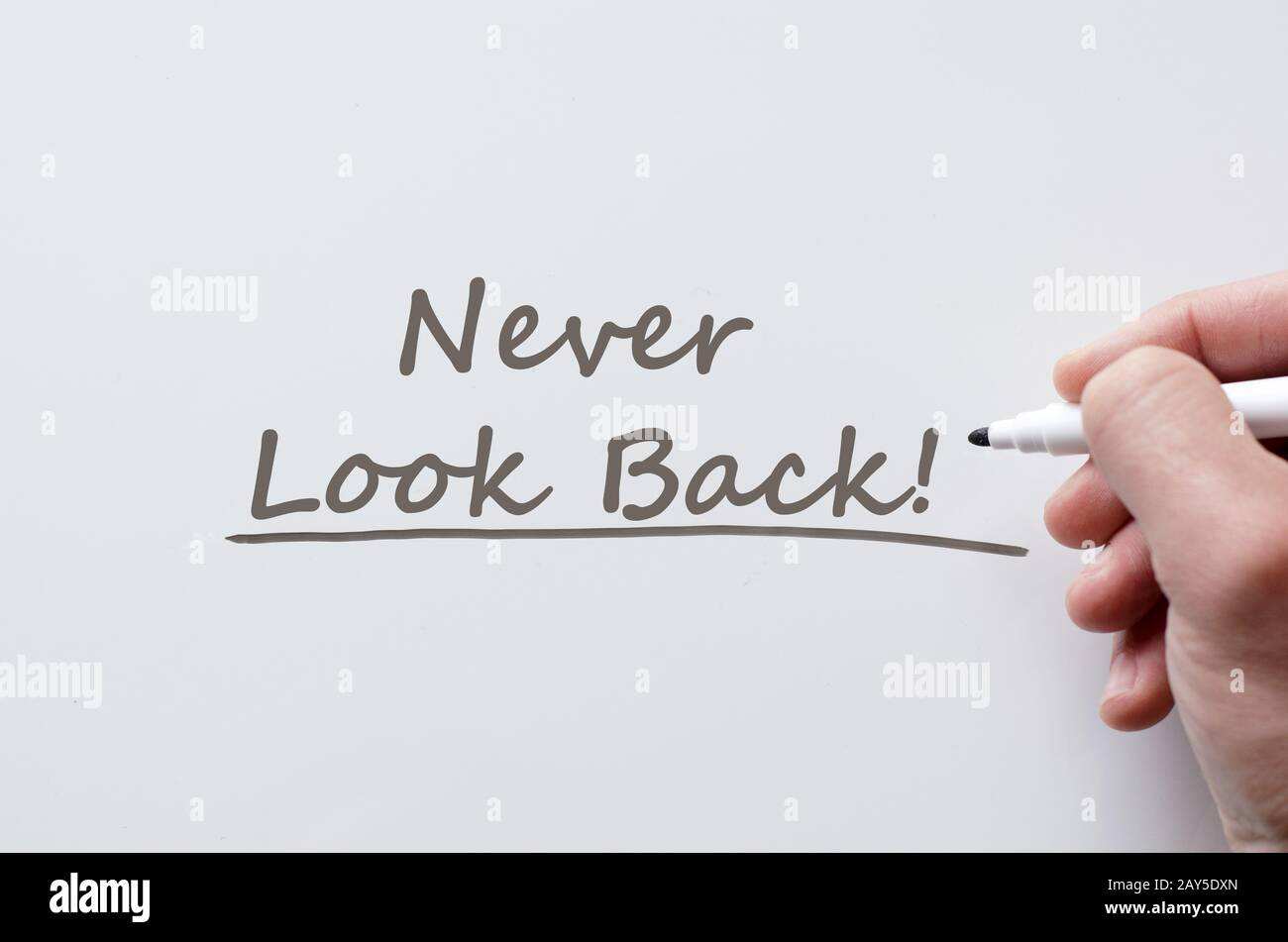 Never look back written on whiteboard Stock Photo - Alamy