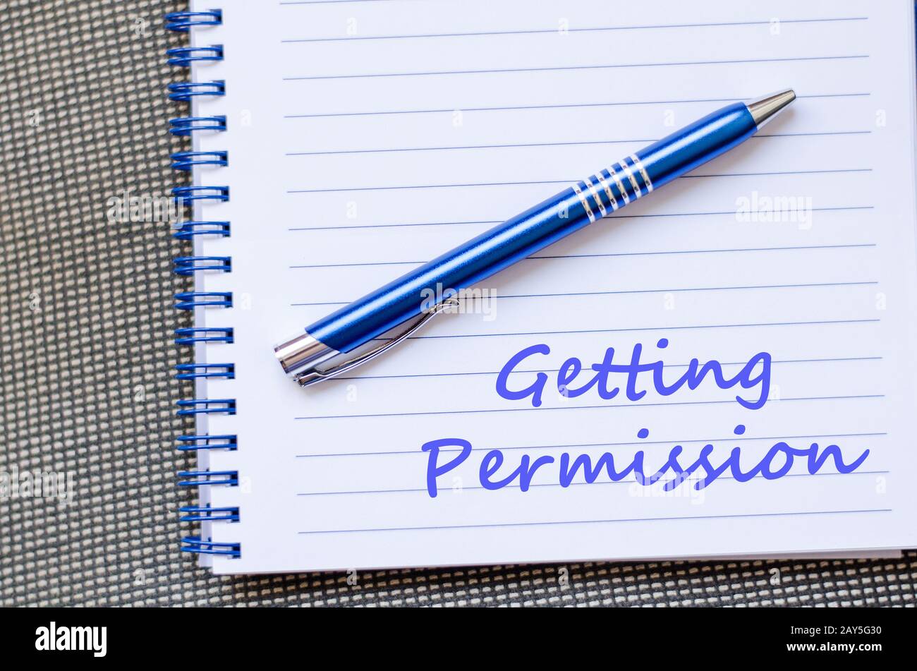 Getting permission write on notebook Stock Photo - Alamy