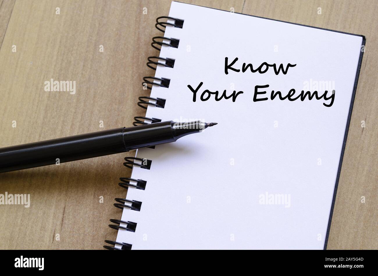 Know your enemy write on notebook Stock Photo - Alamy