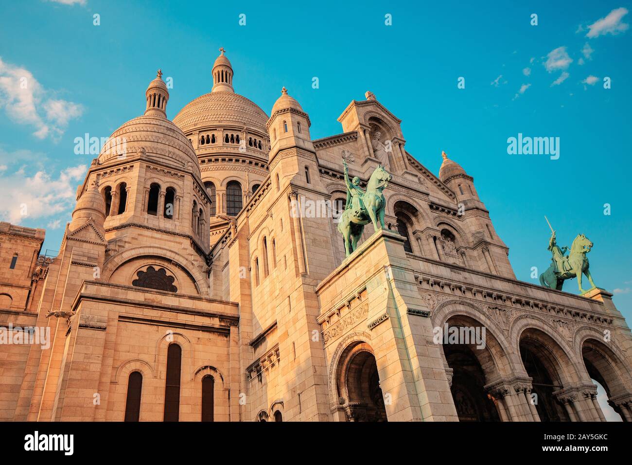 Romantic Parisian sunset over Sacre Coeur basilica on Montmartre hill ...