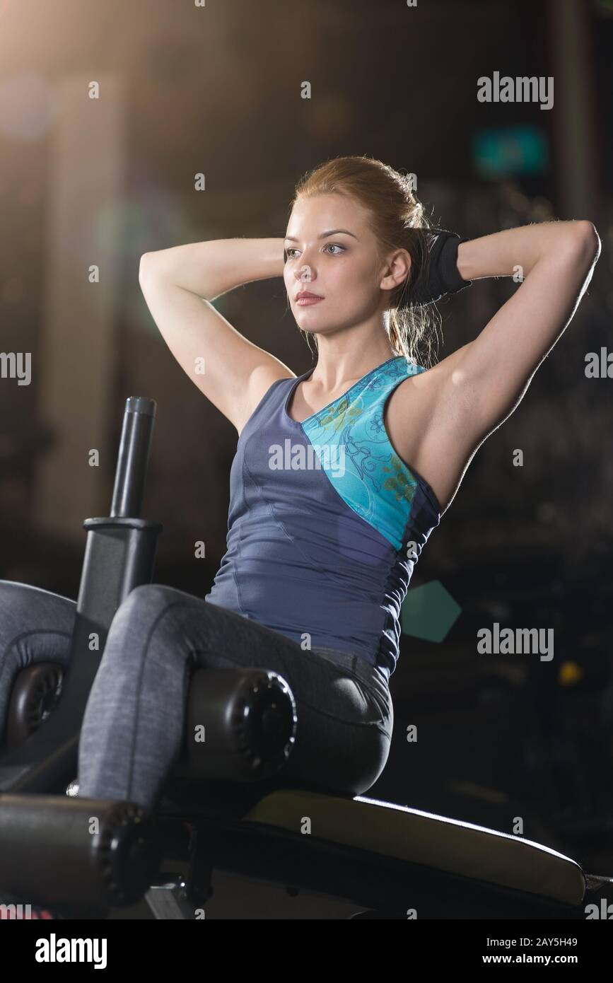 Woman doing strength exercises for abs muscles Stock Photo - Alamy