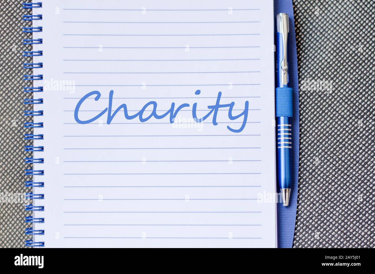 Charity write on notebook Stock Photo - Alamy