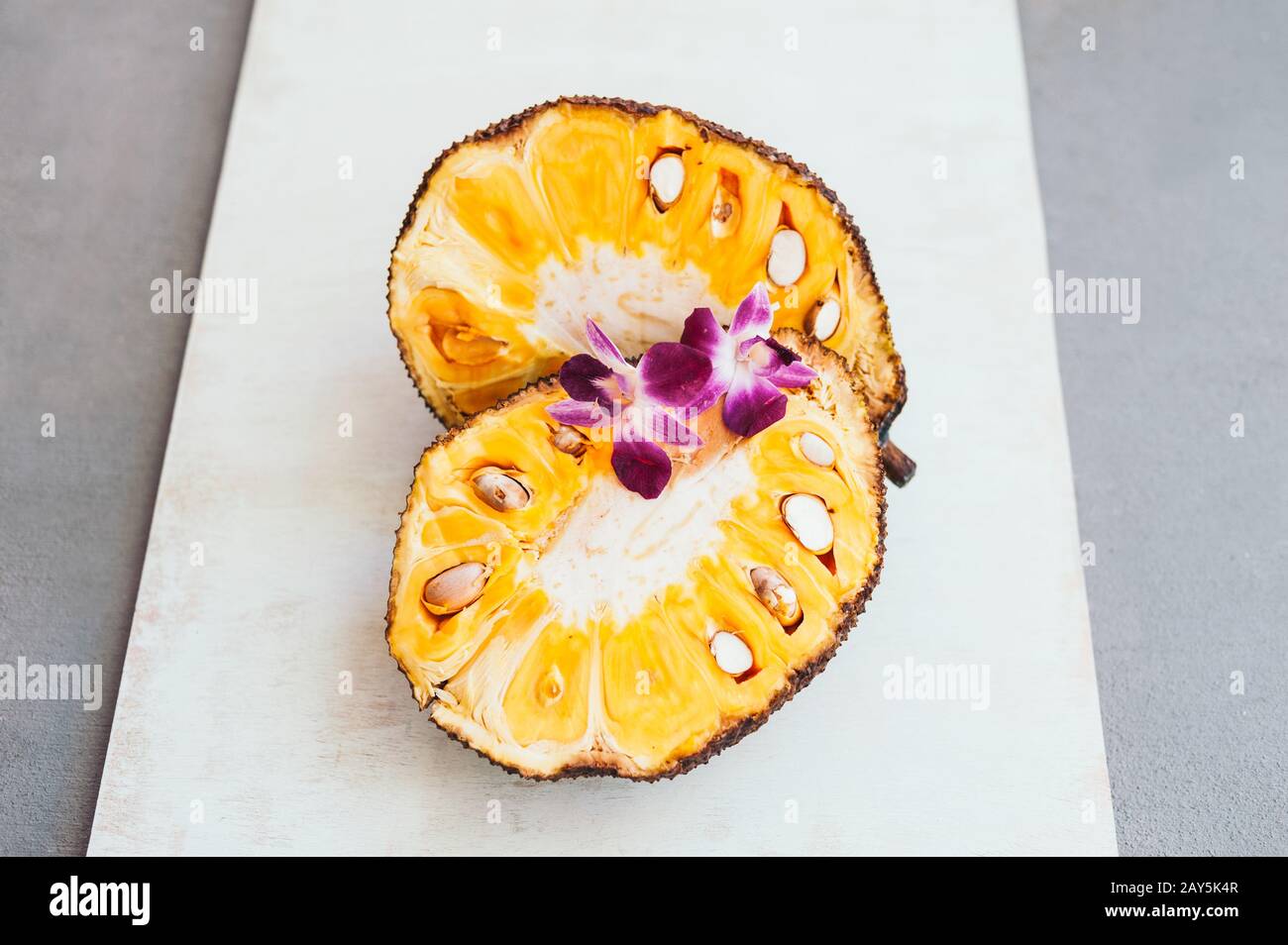 Fresh ripe jackfruit. Tropical fruit with purple orchids on it ...