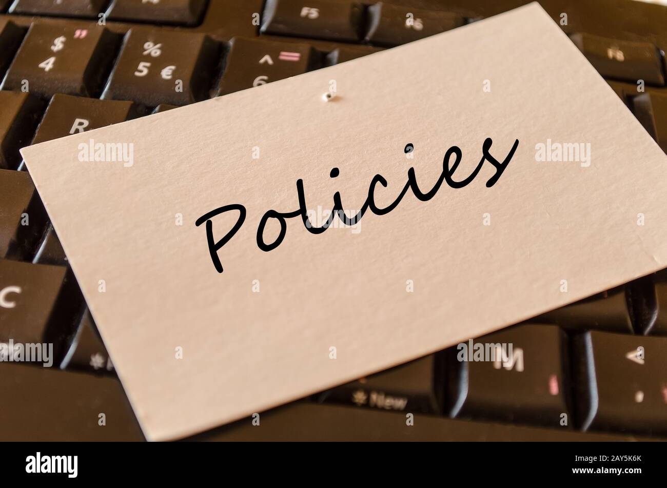 Policies - note on keyboard in the office Stock Photo - Alamy