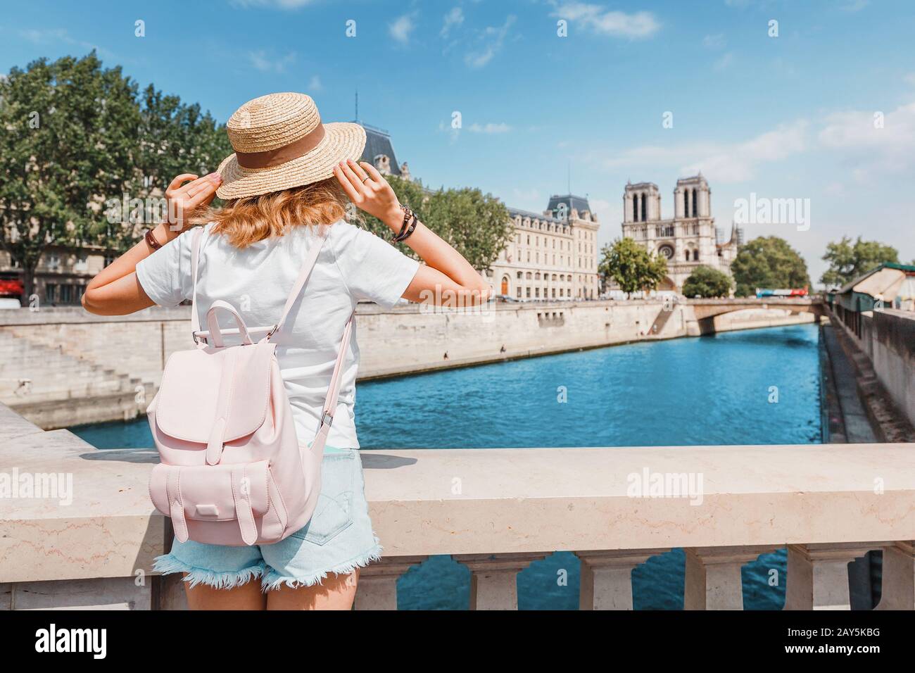 Happy traveler girl blogger takes photos of Notre Dame De Paris and the ...