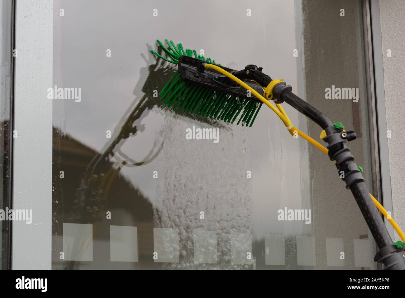 Window cleaning with washing brush on large window areas Stock Photo ...