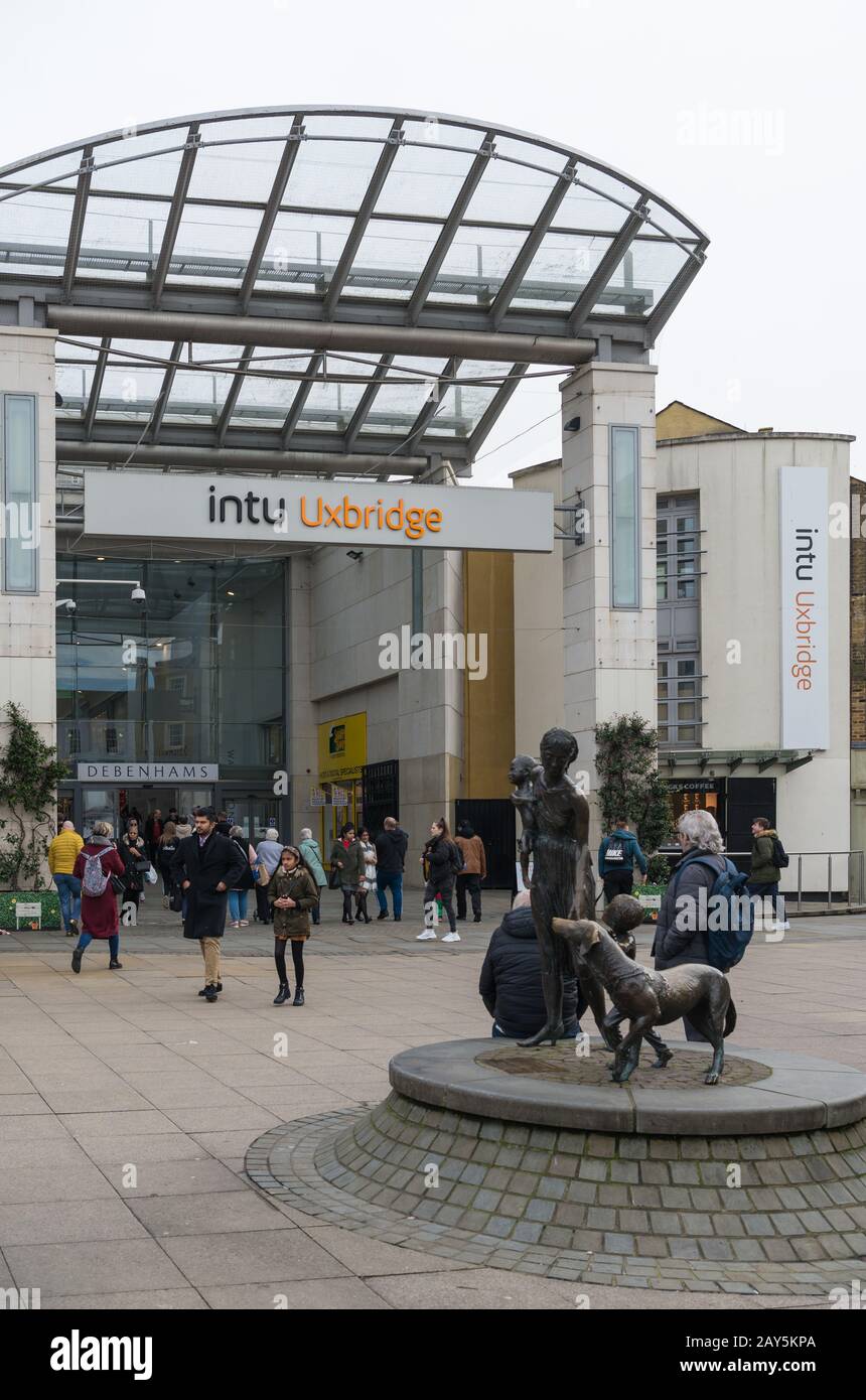 People out and about shopping pass in and out of the entrance to the ...