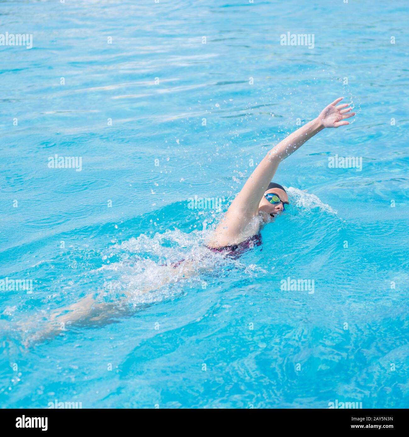 Women swimming in pool with blue cap hi-res stock photography and ...