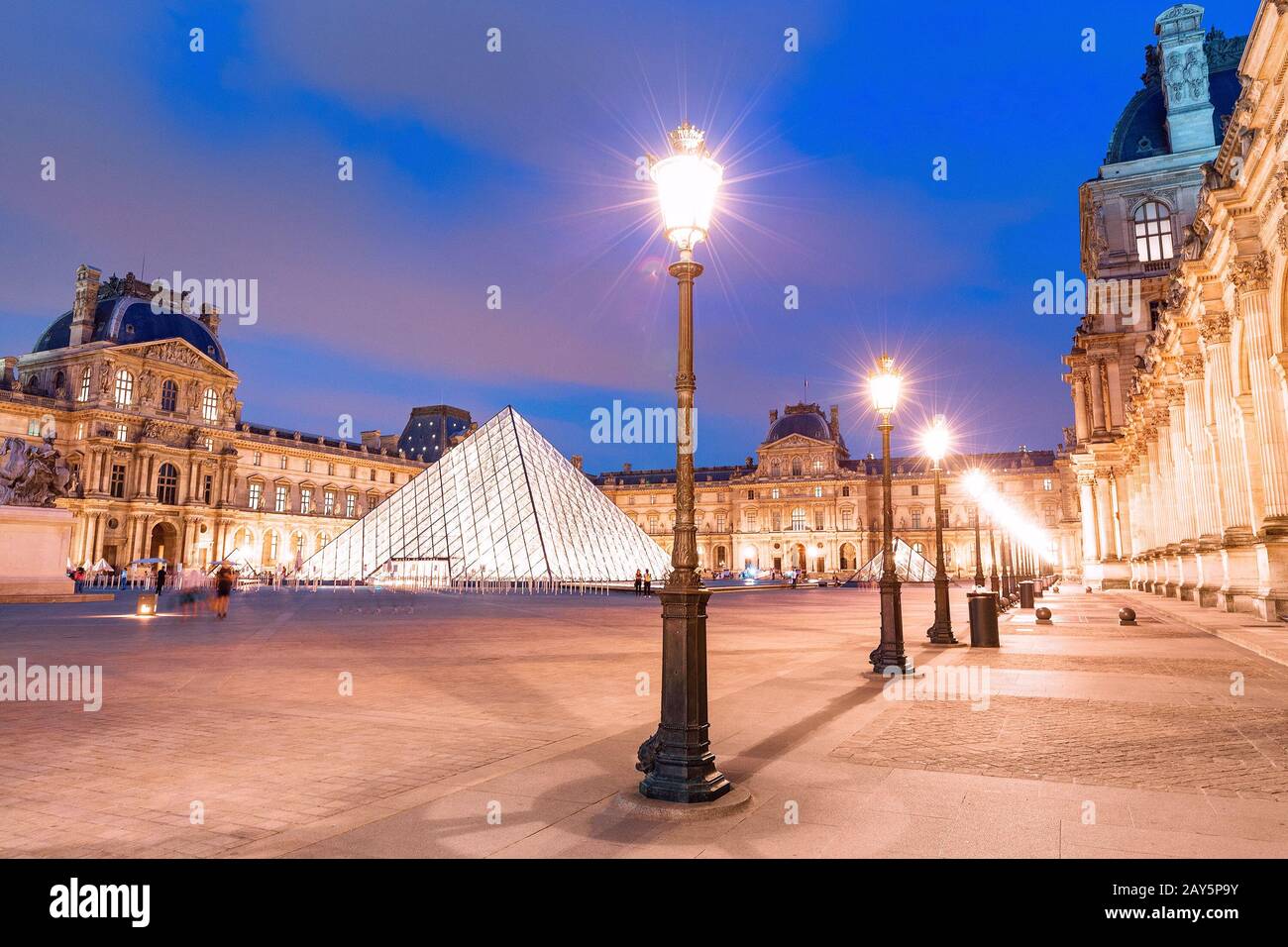 Louvre Museum complex at night illuminated with lanterns Stock Photo ...