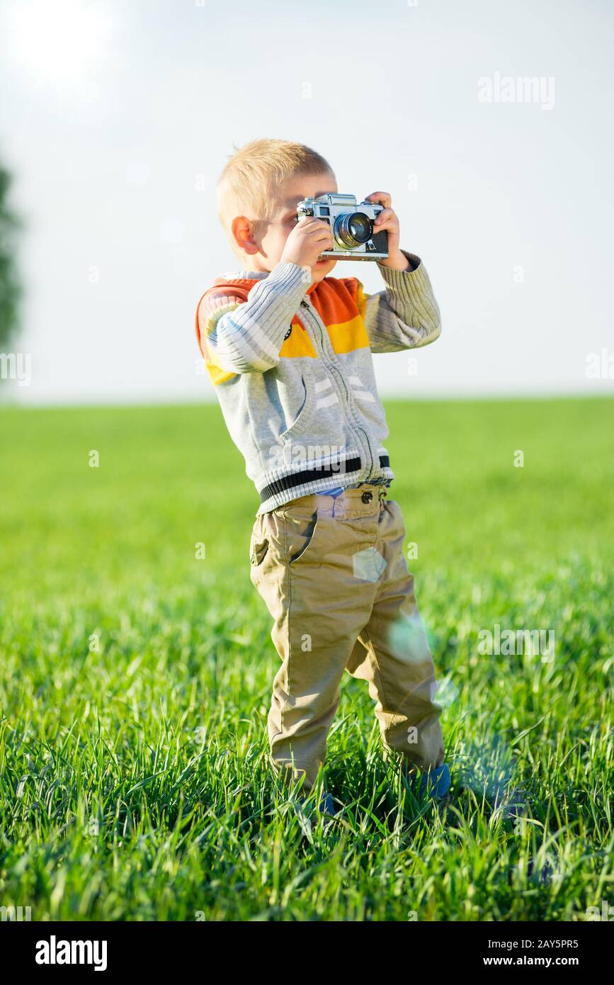 Little boy with an old camera shooting outdoor Stock Photo - Alamy