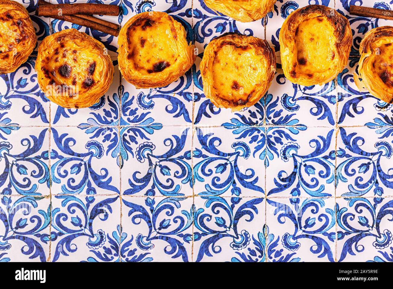 Egg tart, traditional Portuguese dessert, pastel de nata. Azulejo tile ...