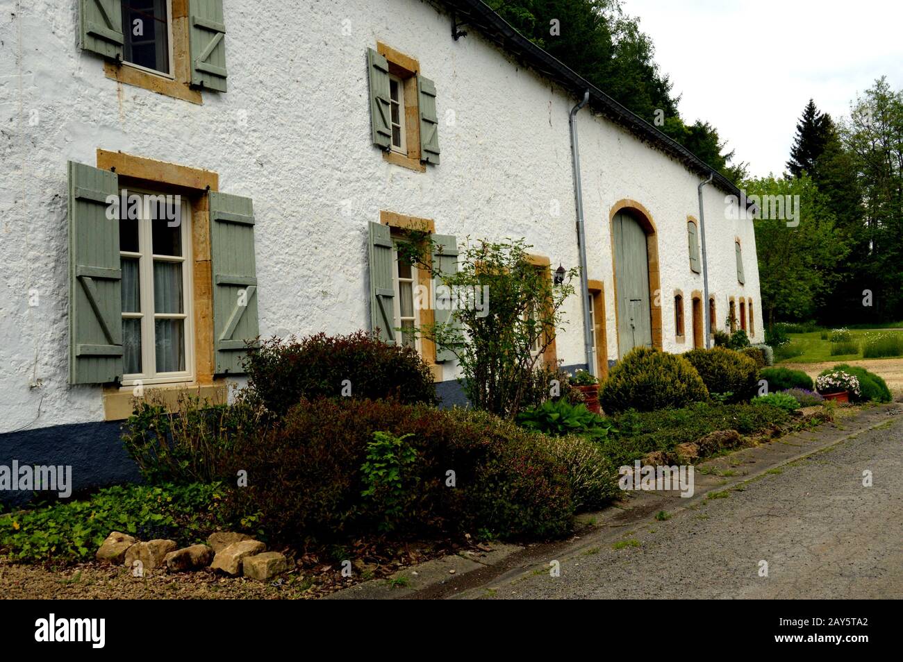 Old farm with a facade in thatch of white color and the flower and ...