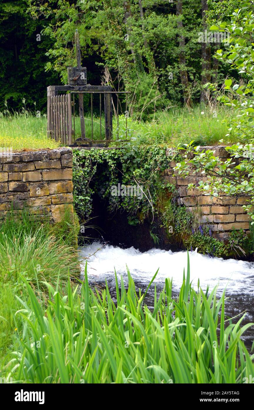 Small lock on a small black brook of color Stock Photo - Alamy