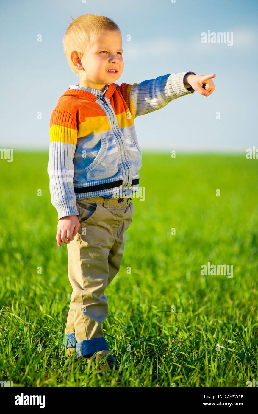 Portrait of happy joyful beautiful little boy outdoor at countryside ...