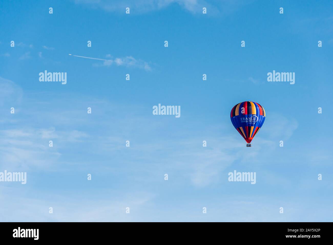 Jet airplane and a balloon on the blue sky background Stock Photo - Alamy