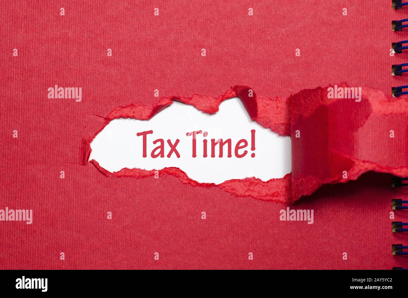 The word tax time appearing behind torn paper Stock Photo - Alamy