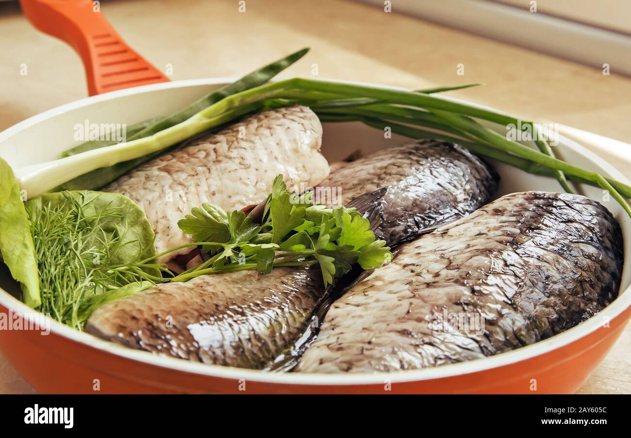 Fish and components for her preparation in a large skillet Stock Photo ...
