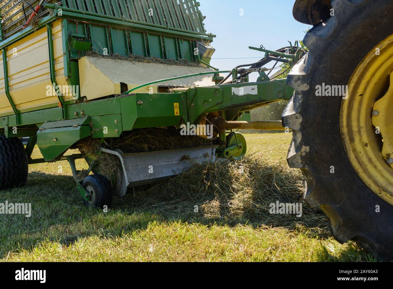 Hay harvesting with a loader wagon - close-up cattle fodder Stock Photo ...