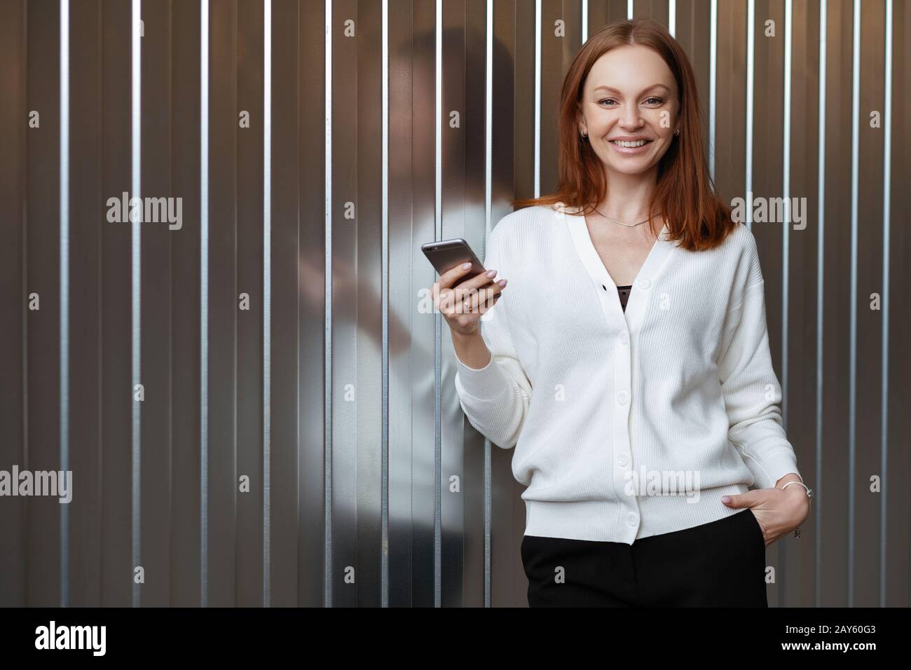 Female sending text message via mobile phone Stock Photo - Alamy