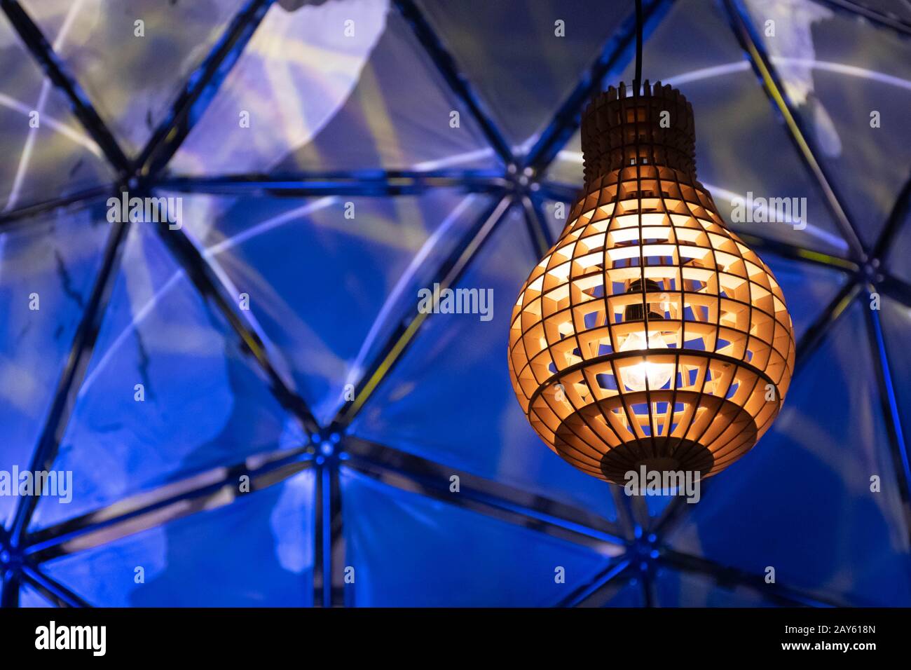 Wooden lamp with warm light and blue terrestrial sphere on the ...
