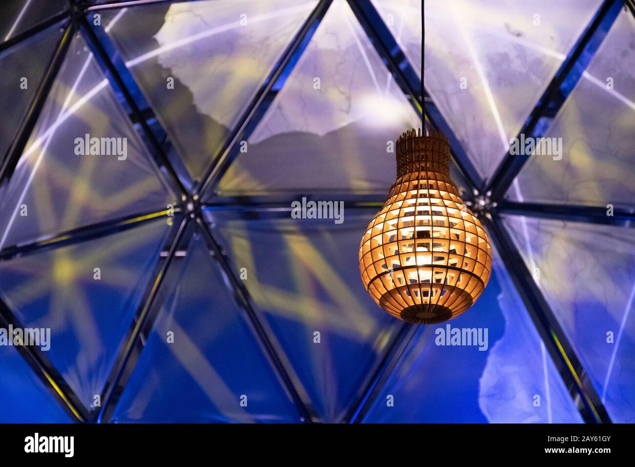 Wooden lamp with warm light and blue terrestrial sphere on the ...