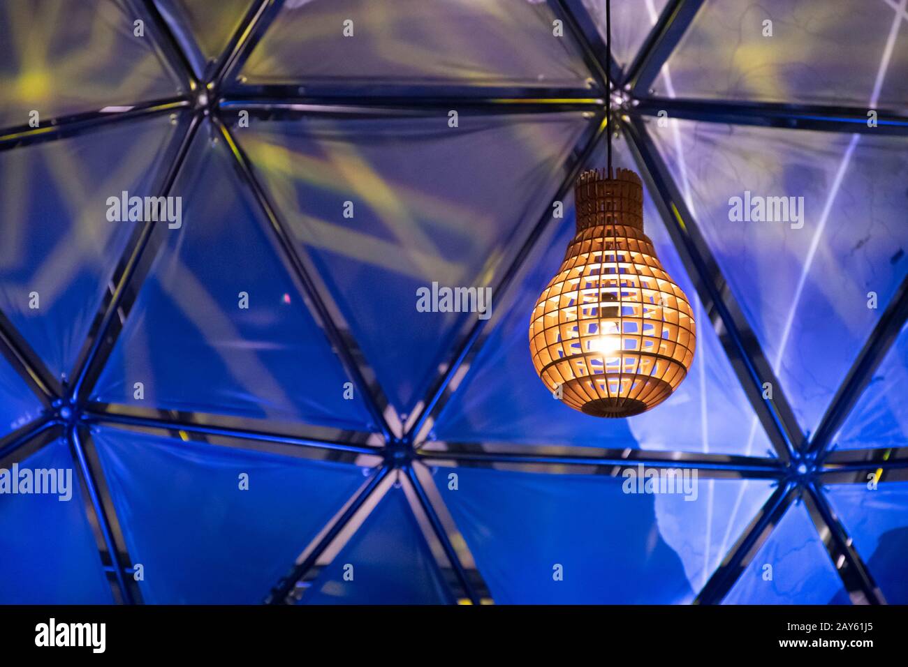 Wooden lamp with warm light and blue terrestrial sphere on the ...