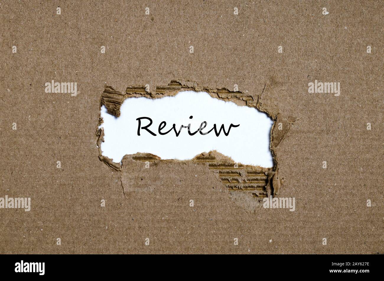 The word review appearing behind torn paper Stock Photo - Alamy
