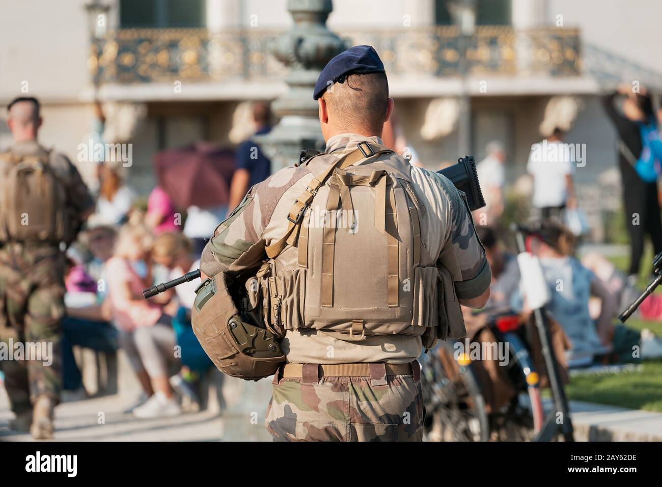 An unidentified Man in military uniform and with a military weapon ...