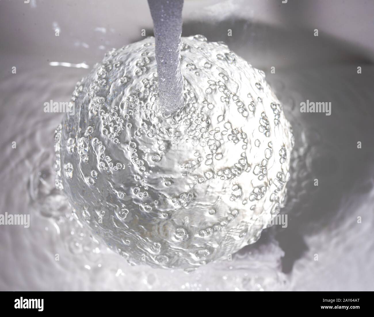 Water jet hits a glass ball Stock Photo - Alamy