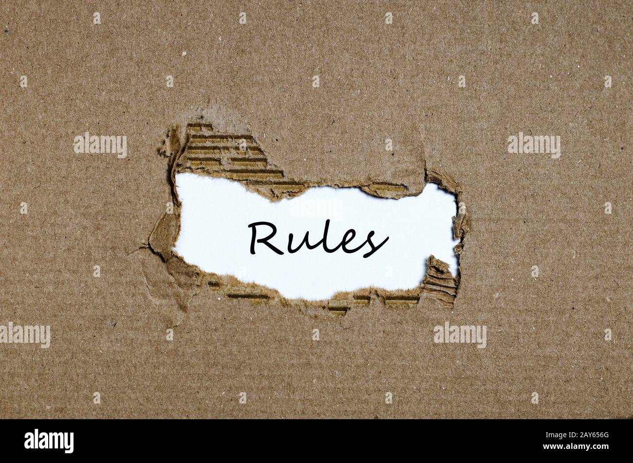 The word rules appearing behind torn paper Stock Photo - Alamy