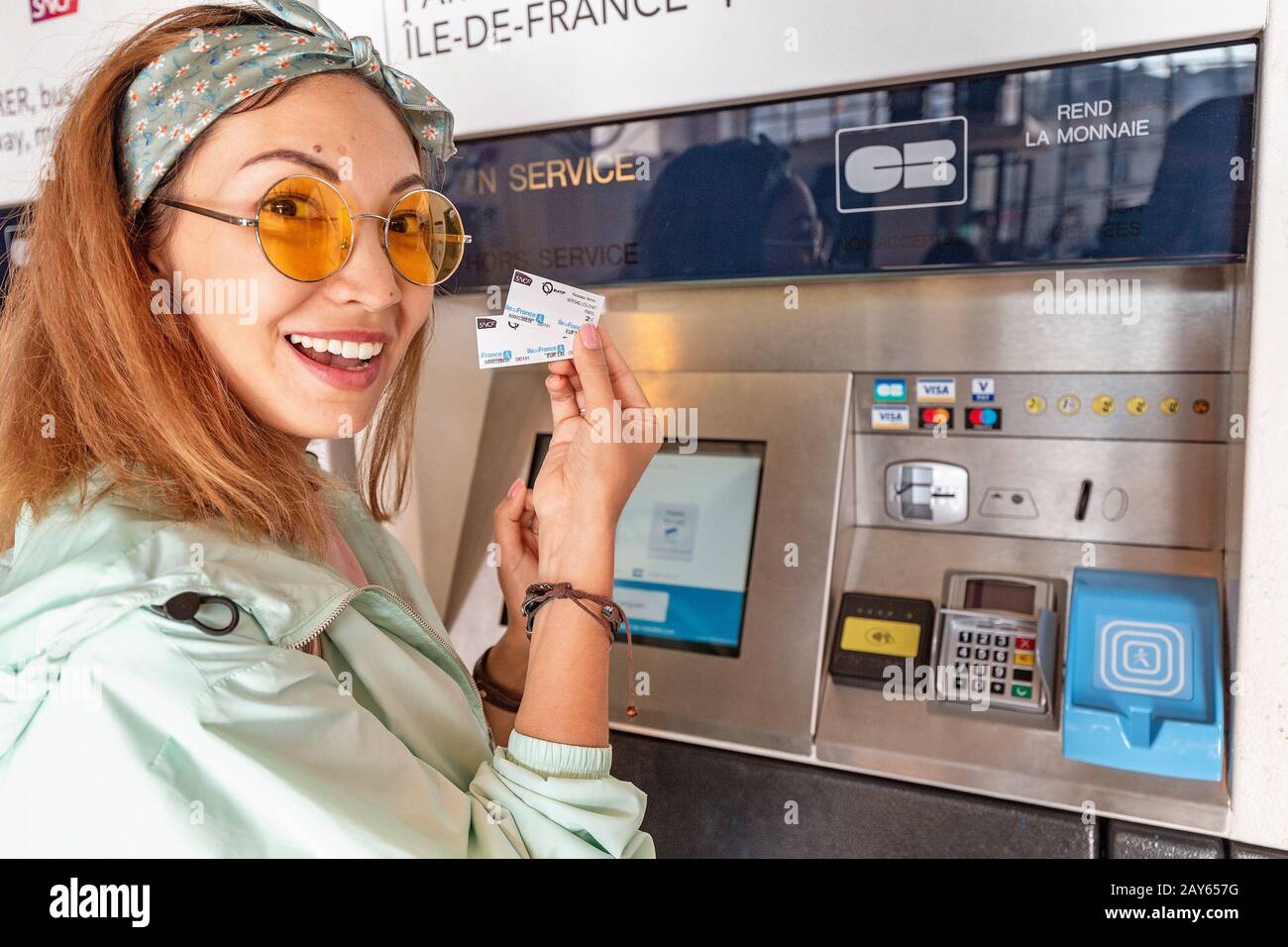 30 july 2019, France, Versailles: Asian woman buying tickets in railway ...