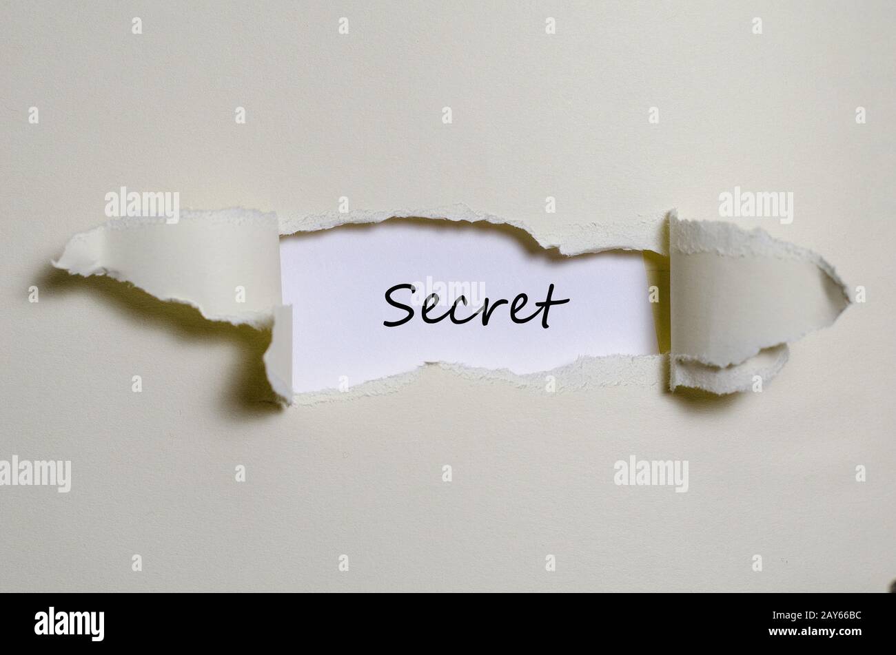 The word secret appearing behind torn paper Stock Photo - Alamy