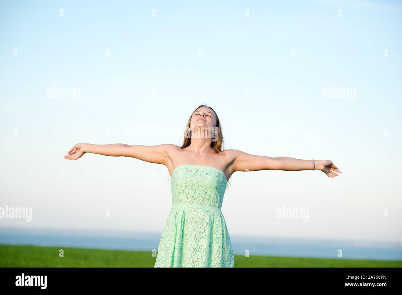 Happiness woman stay outdoor under sunlight of sunset Stock Photo - Alamy