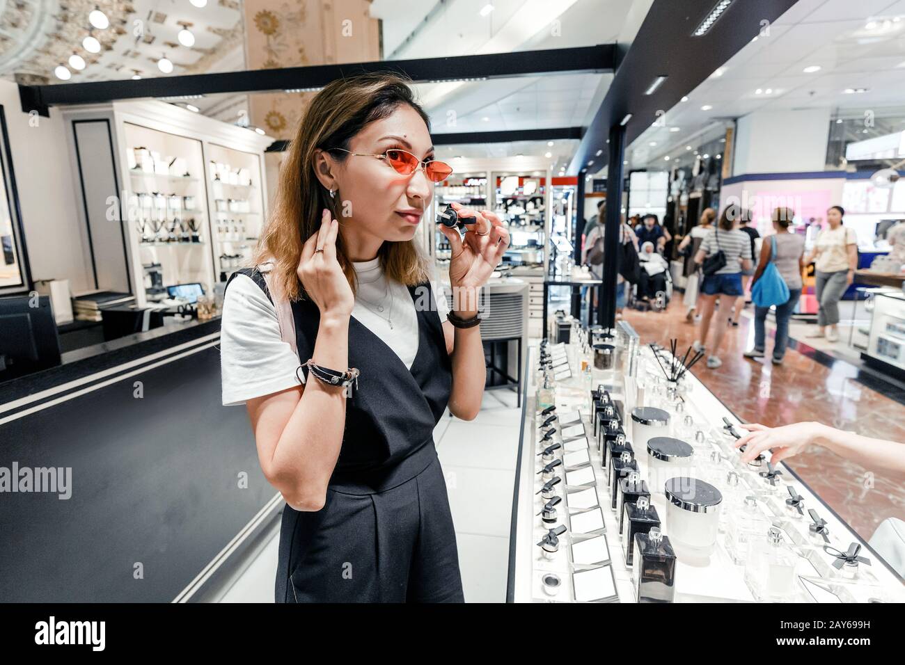 Asian girl smelling a tester of the new fragrance of the popular ...