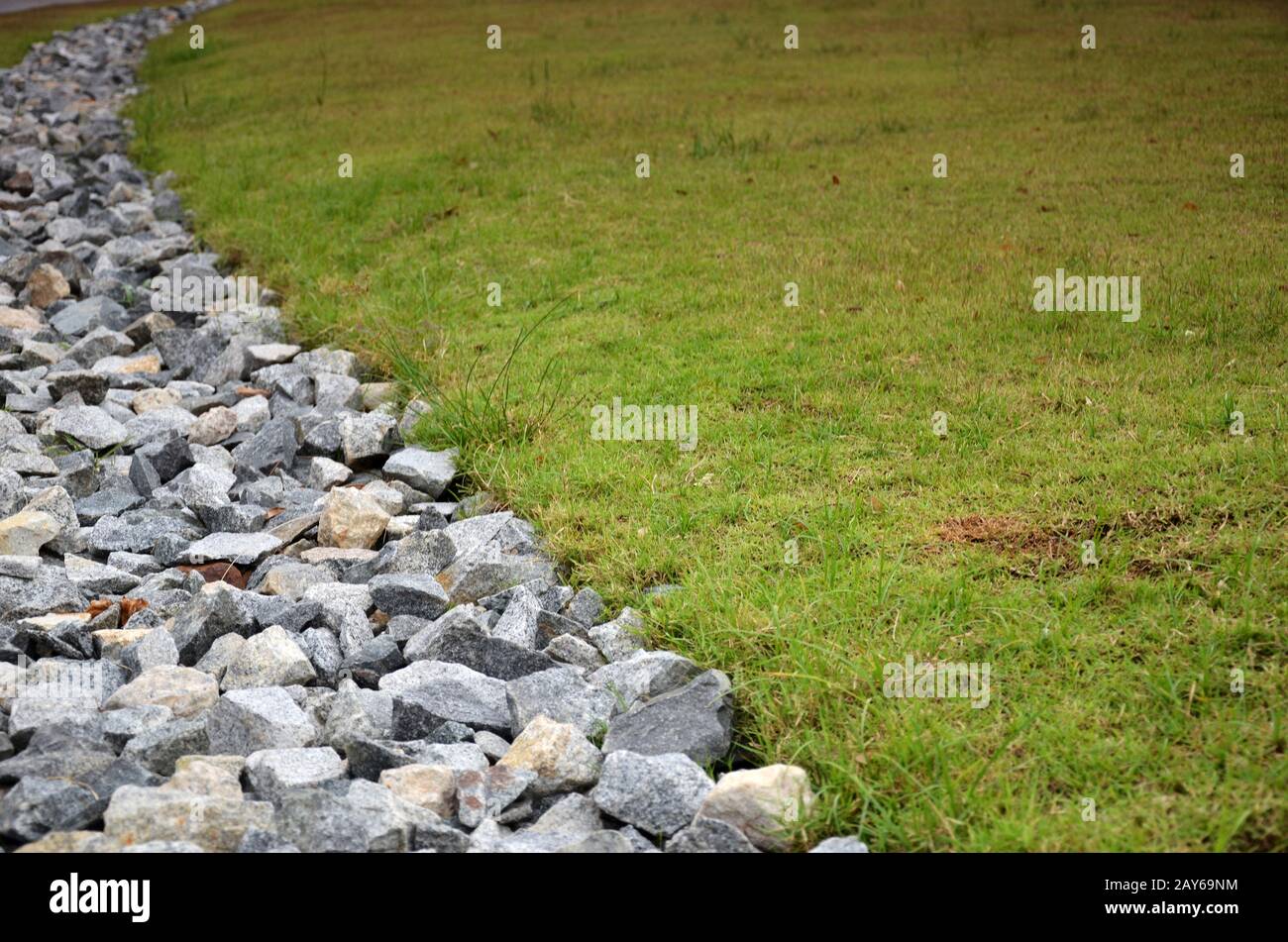 Stone and green grass Stock Photo - Alamy