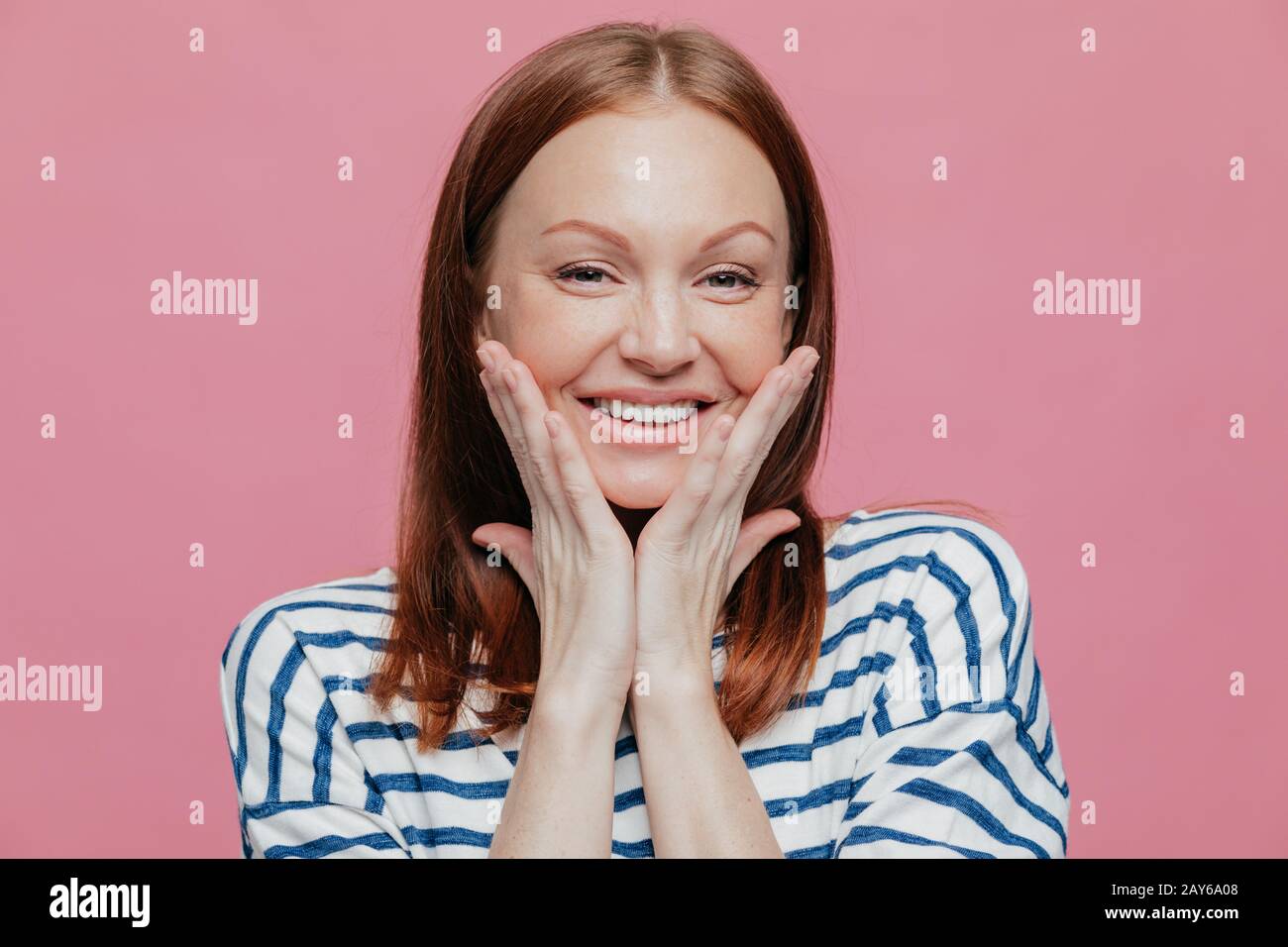 Headshot of smiling young European woman has make up, smiles broadly ...