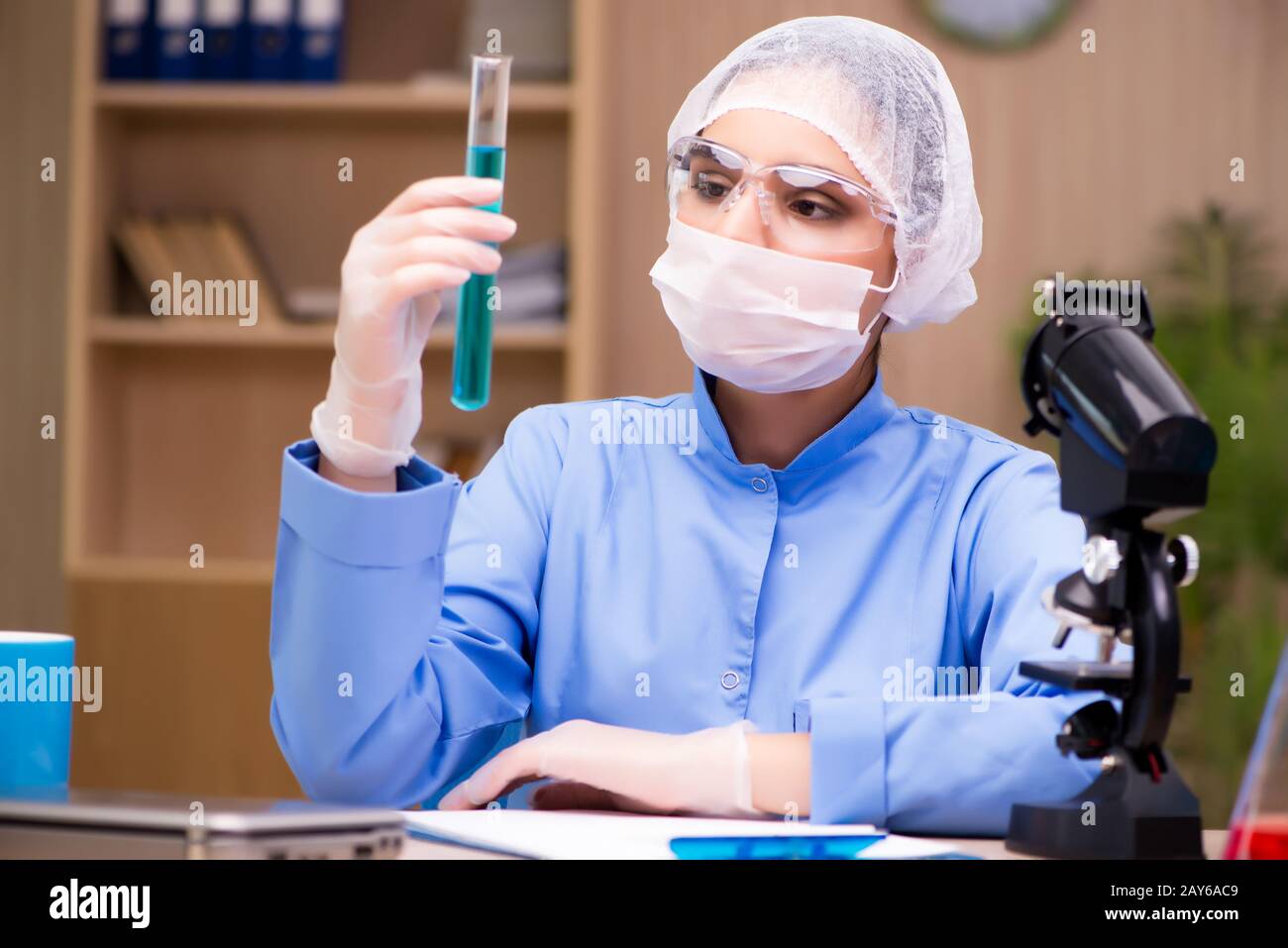 Lab chemist working with microscope and tubes Stock Photo - Alamy