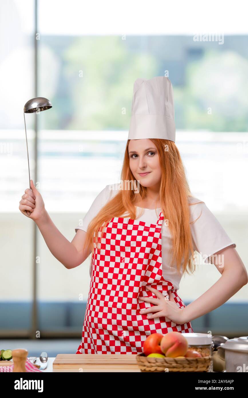 Redhead cook working in the kitchen Stock Photo - Alamy
