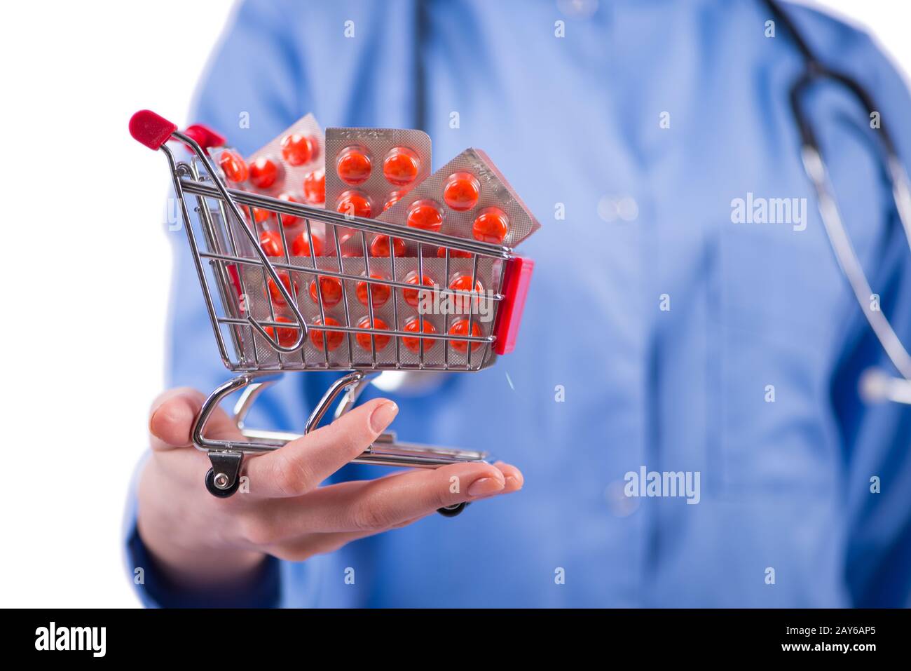 Doctor with shopping cart full of pills isolated on white Stock Photo ...