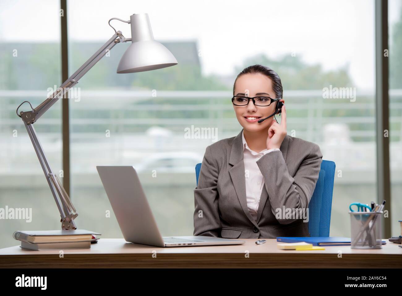 Call center operator working at her desk Stock Photo - Alamy