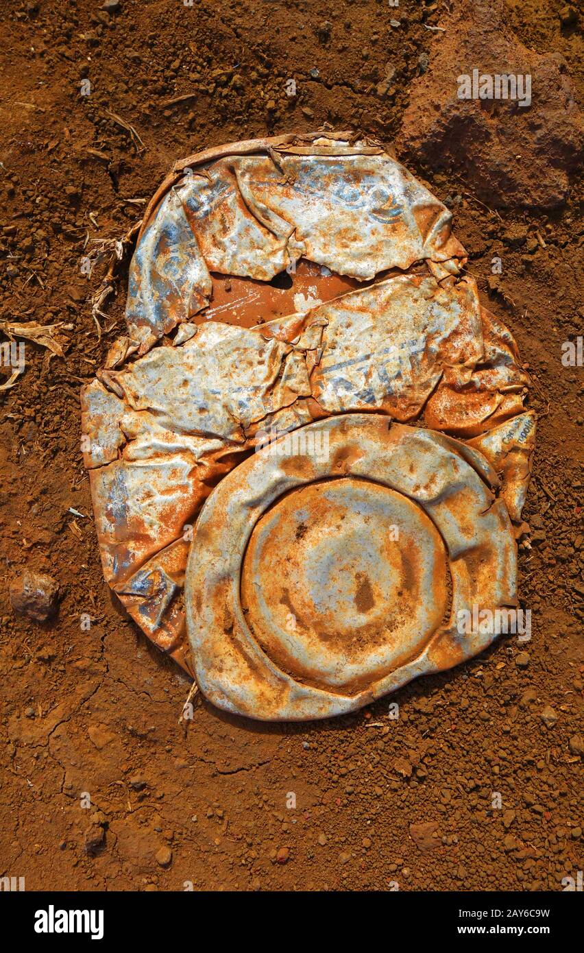 Old crushed rusty tin can Stock Photo - Alamy