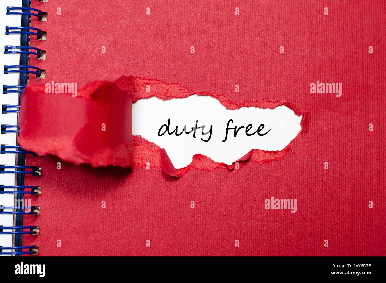 The word duty free appearing behind torn paper Stock Photo - Alamy