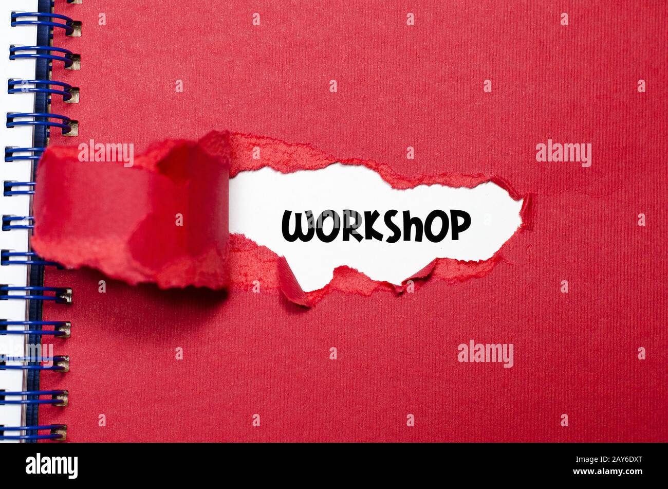 The word workshop appearing behind torn paper Stock Photo - Alamy