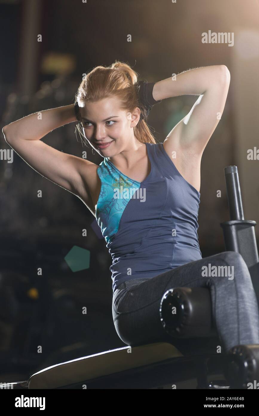 Woman doing strength exercises for abs muscles Stock Photo - Alamy