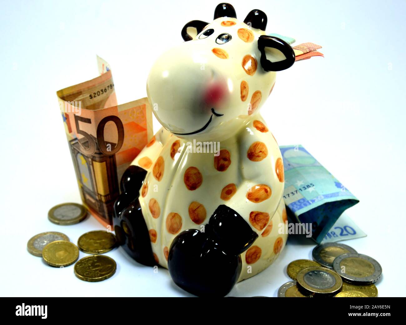 Cow money box sat on the ground with tickets and rooms in his feet ...