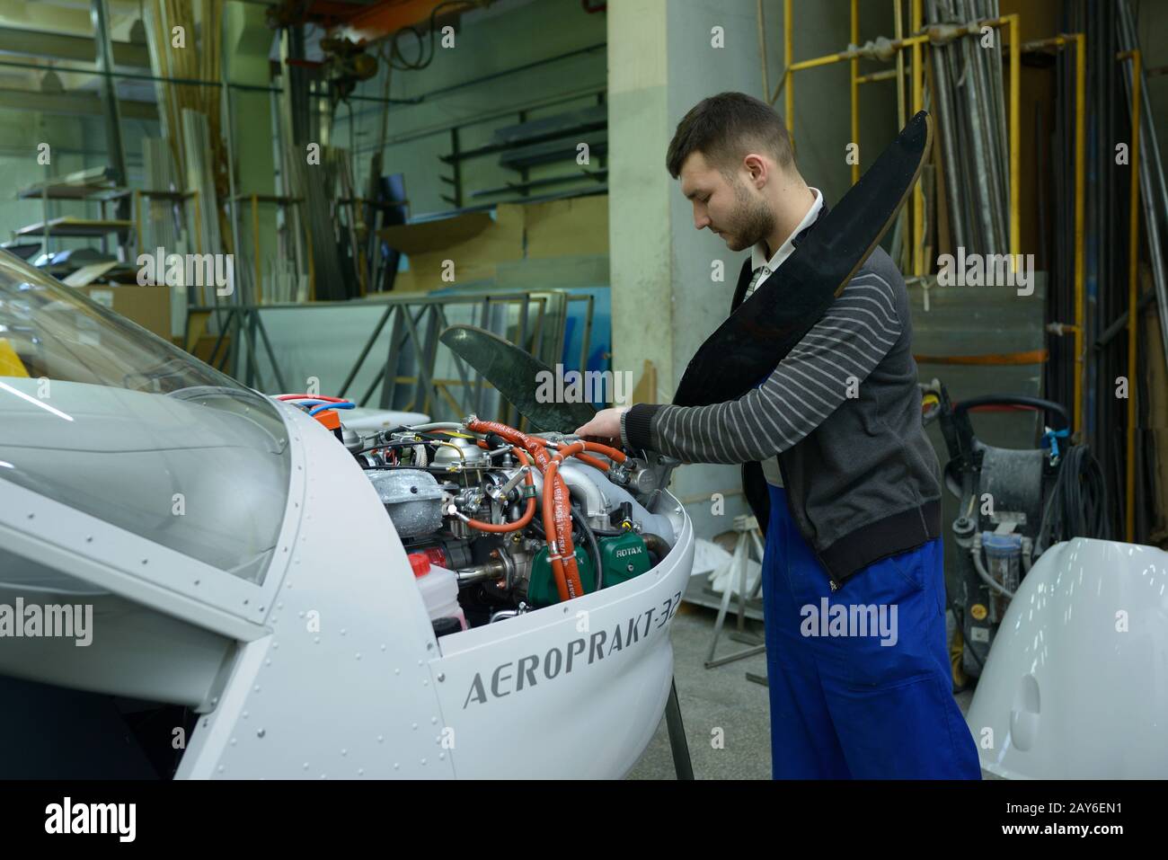 Fitter fixing propeller on the body of the light plane, assembling it ...