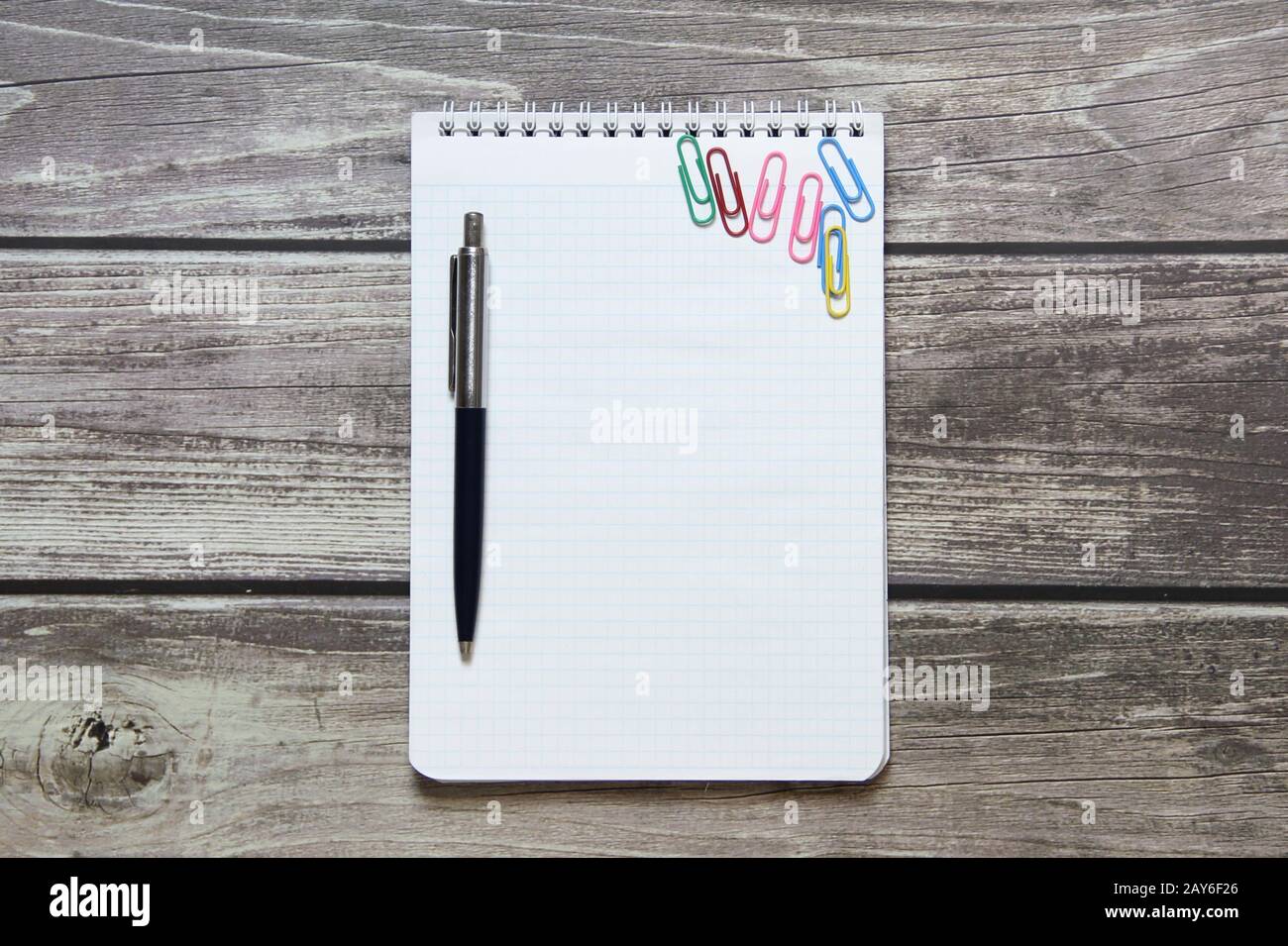 Notepad with a blank white sheet in a checker paper and with ball pen ...
