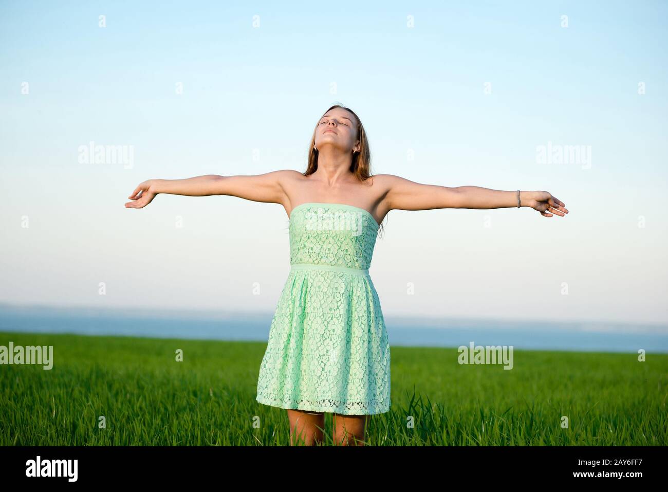 Happiness woman stay outdoor under sunlight of sunset Stock Photo - Alamy